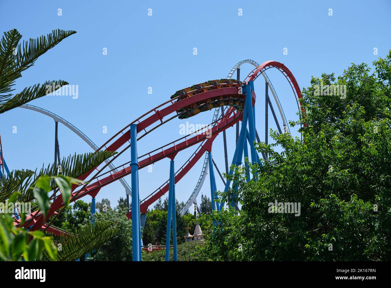 Inverted roller coaster with narrow metal rails, an ideal summer day to ...
