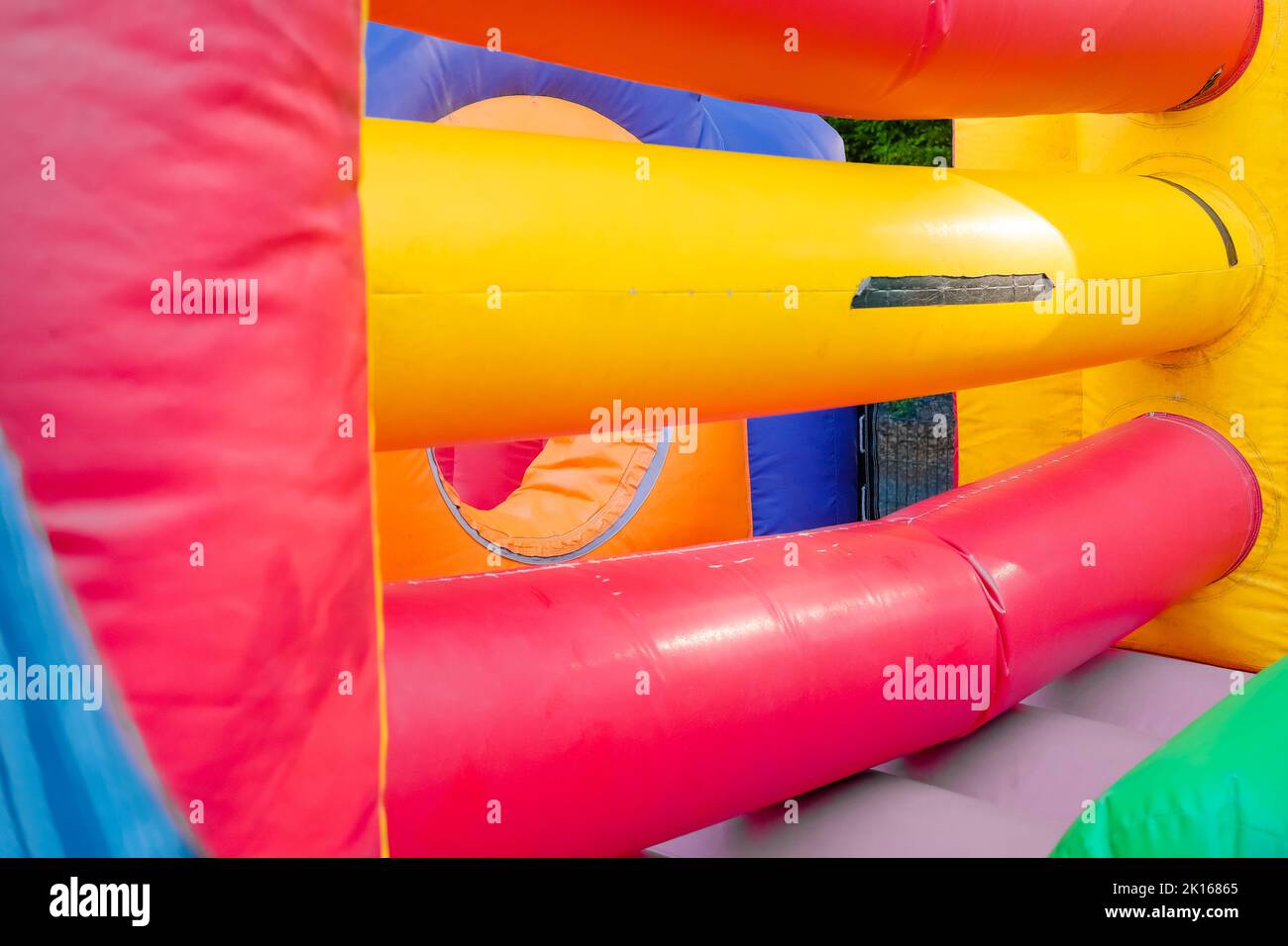 Detail of a brightly colored bouncy castle, empty without children ...