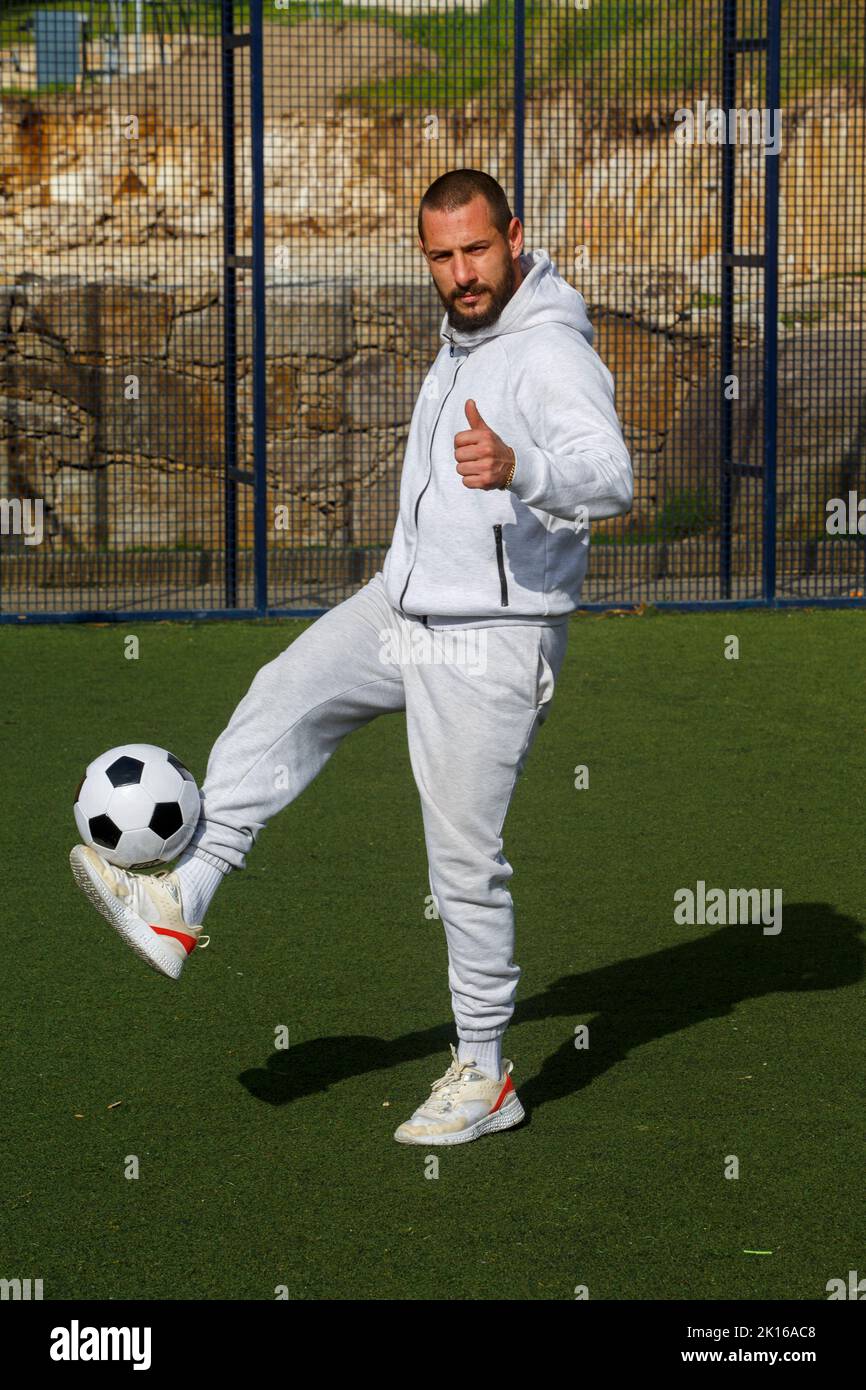 Young male soccer player juggles a ball on a soccer field Stock Photo ...