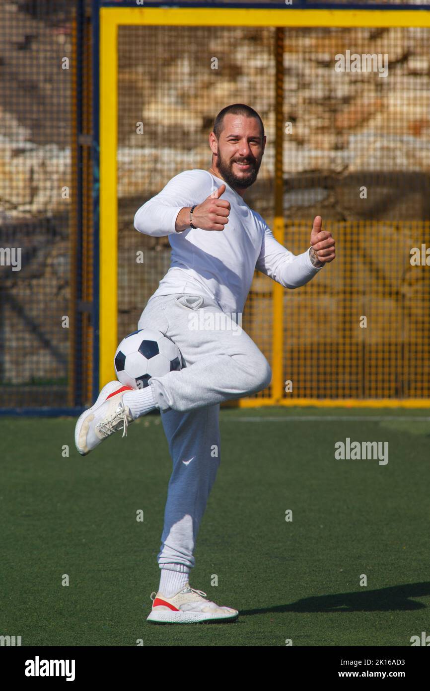Young male soccer player juggles a ball on a soccer field Stock Photo ...