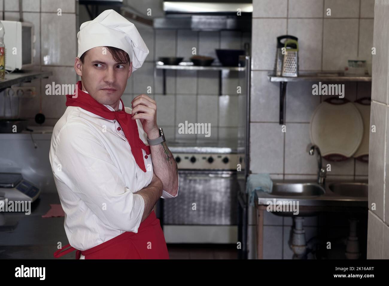 Young Handsome Chef Posing In Kitchen In Restaurant Portrait Of