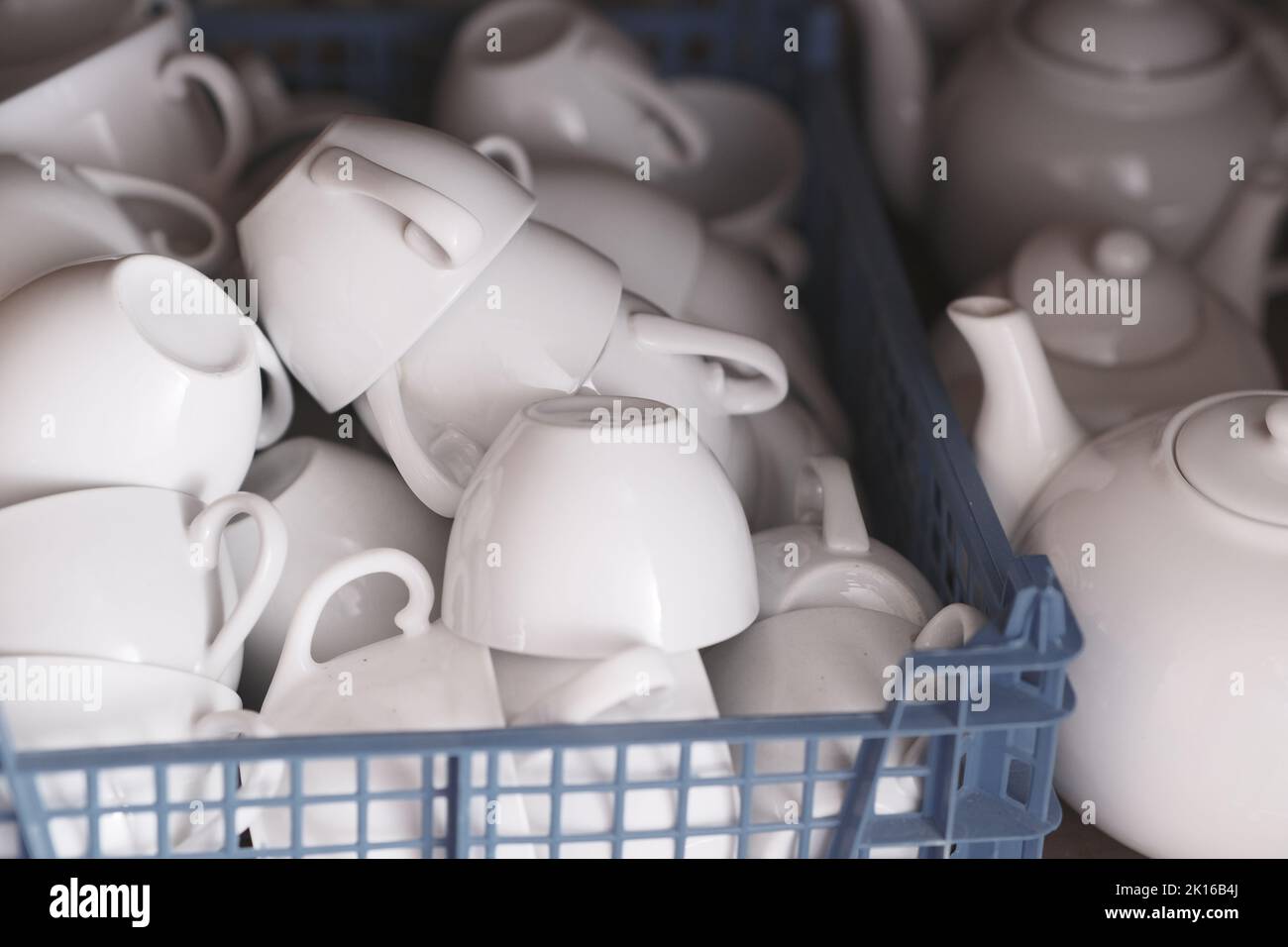 Pile of clean white cups in plastic box. Close up Stock Photo - Alamy