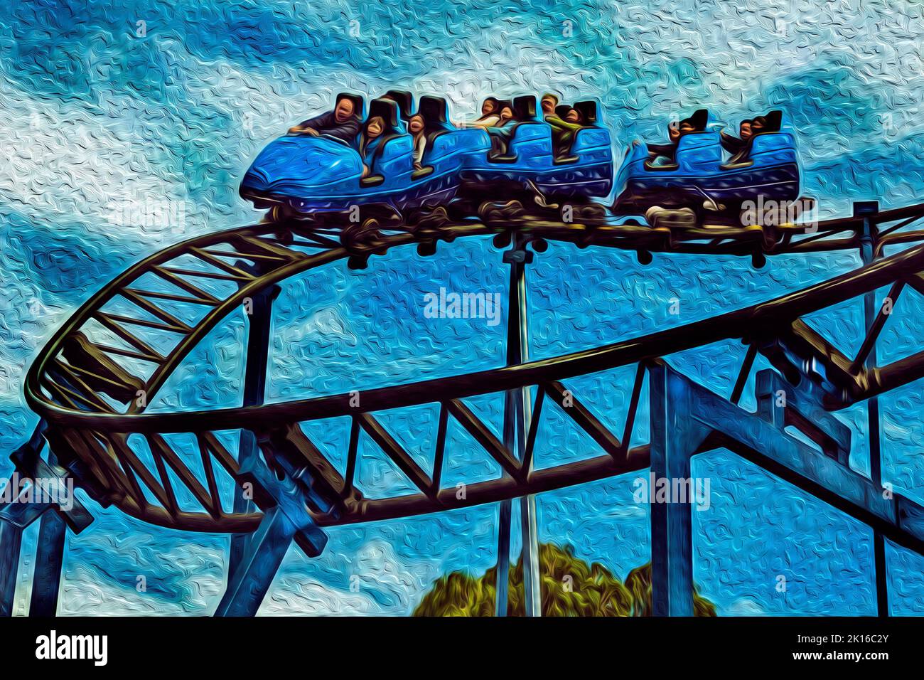 People on a blue cart having fun on roller coaster in an amusement park ...