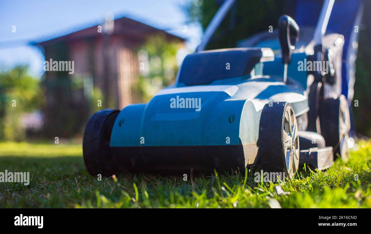 Lawn mover on green grass in modern garden or backyard. Machine for ...