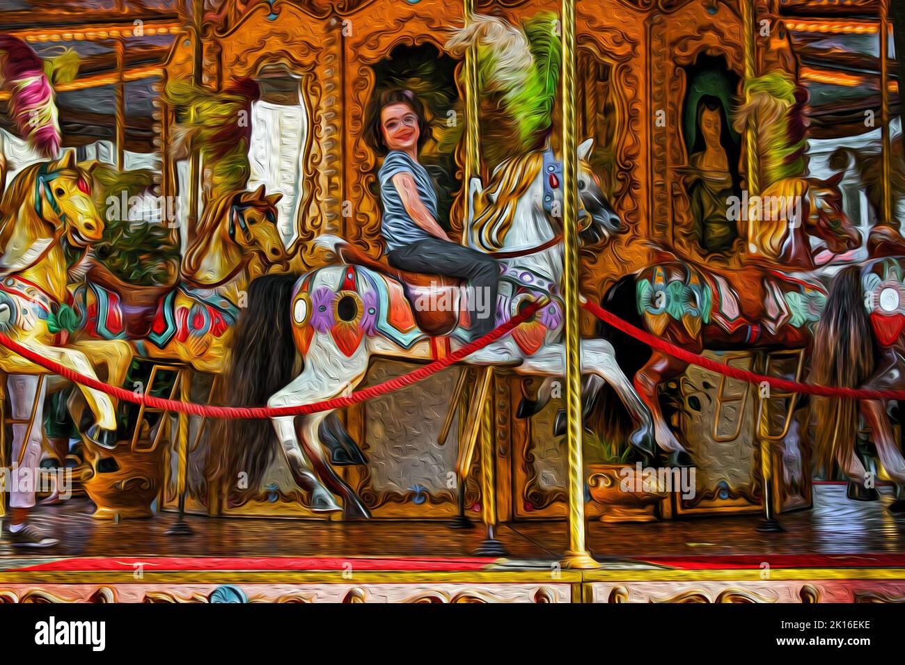 Happy child riding a horse from carousel at sunset in the city of ...