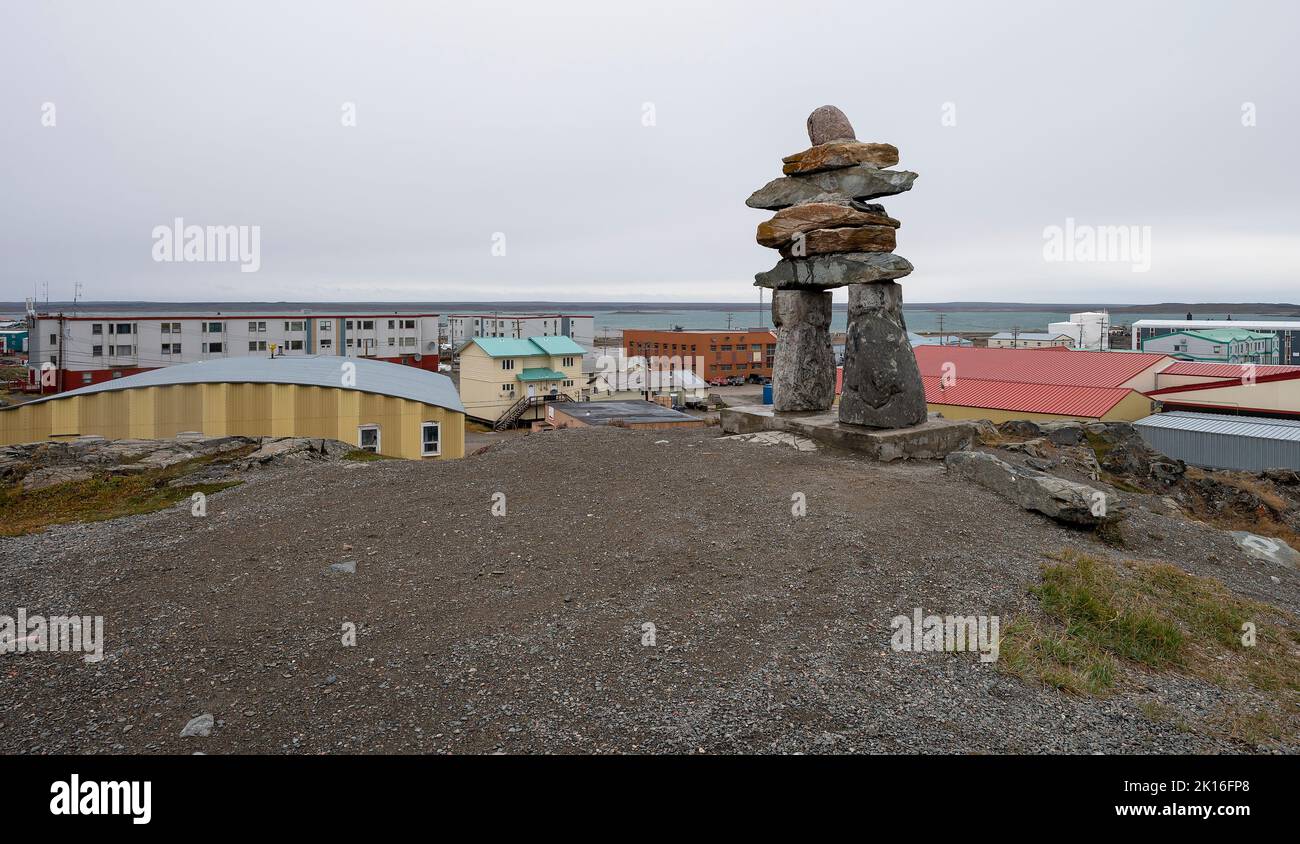 Inukshuk (Inuksuk) on hilltop above the town Rankin Inlet on the Hudson ...