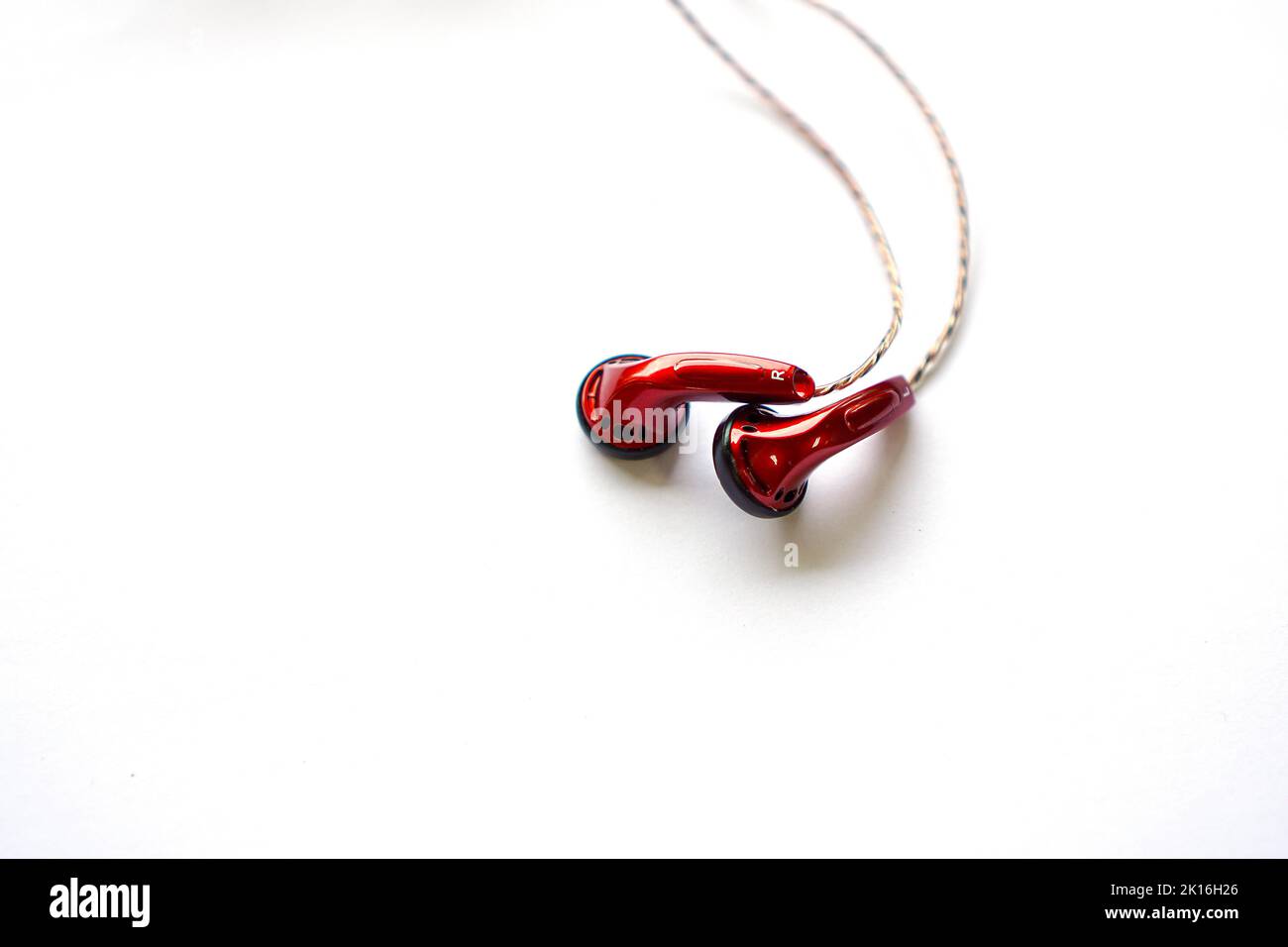 red earphones using wires isolated on white background Stock Photo - Alamy