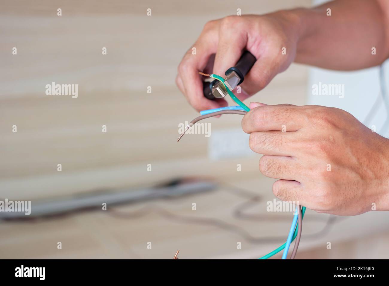 Electrician cuts electrical wires with pliers, Wiring cables ...