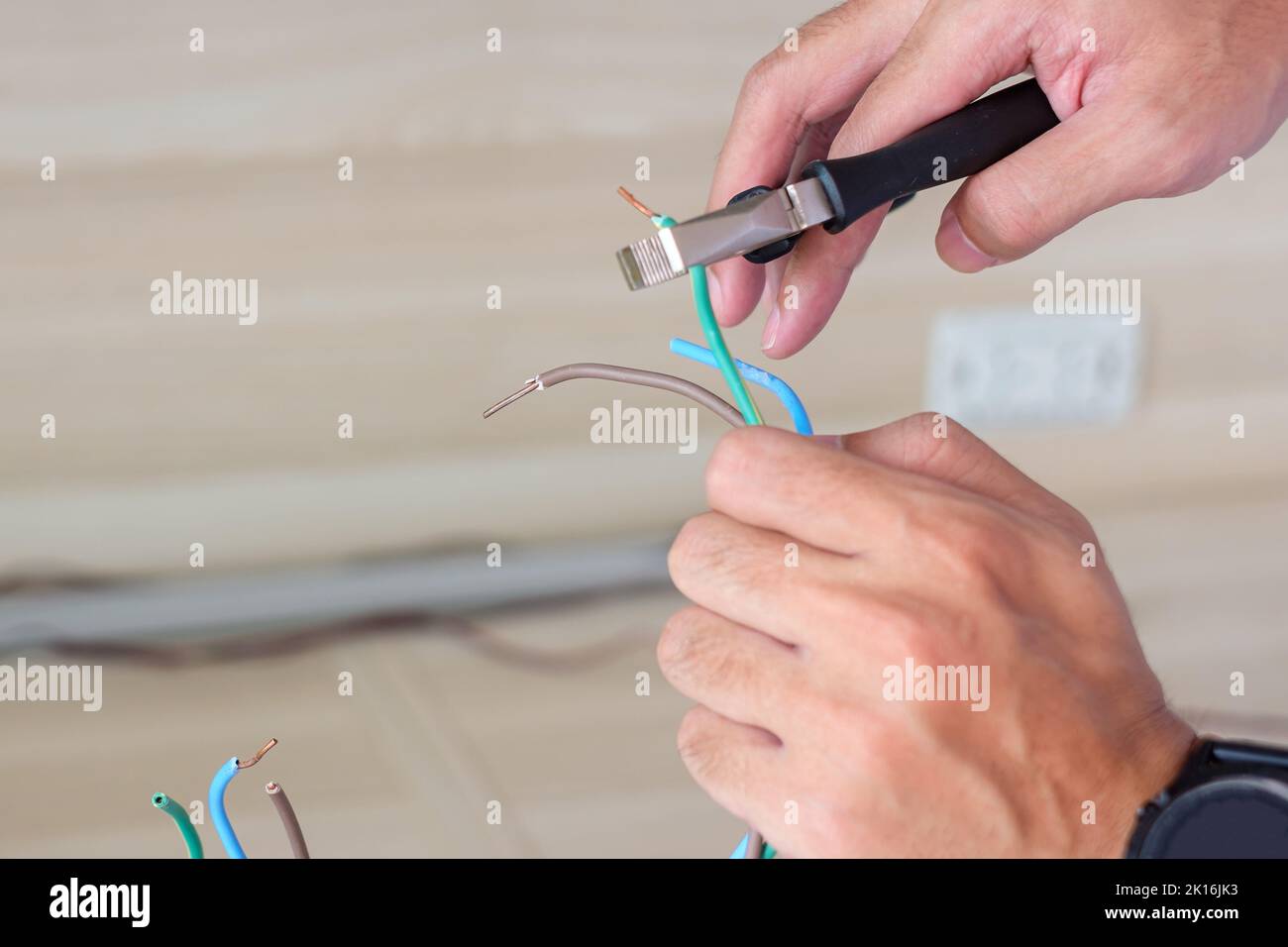 Electrician cuts electrical wires with pliers, Wiring cables ...
