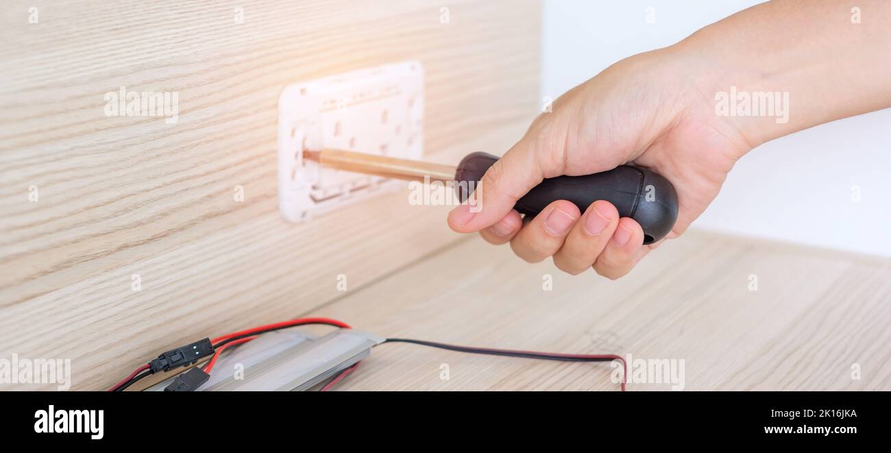 Man hand using screwdriver installing Wire cables for socket plug ...