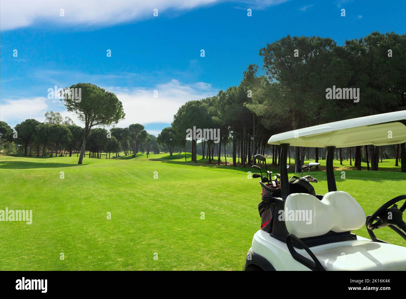 Golf cart on beautiful golf course at sunset Stock Photo - Alamy
