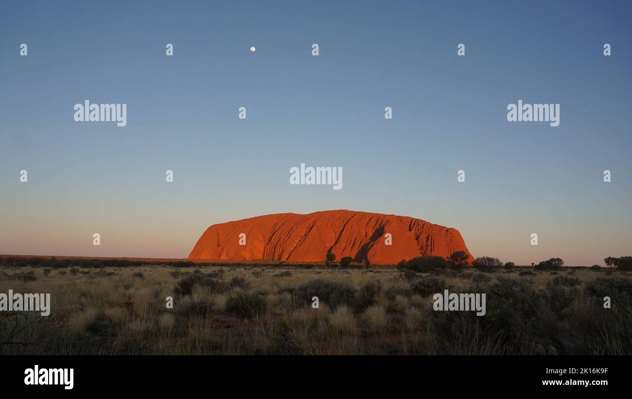A beautiful view of Uluru at Sunset. As the sun goes down the ...