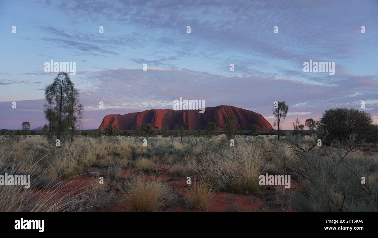 A beautiful view of Uluru at Sunset. As the sun goes down the ...