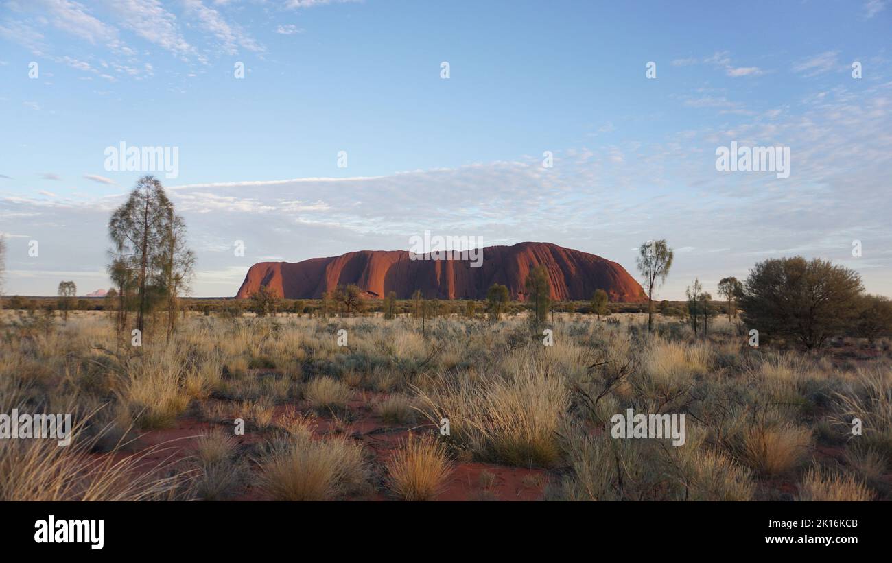 A beautiful view of Uluru at Sunset. As the sun goes down the ...