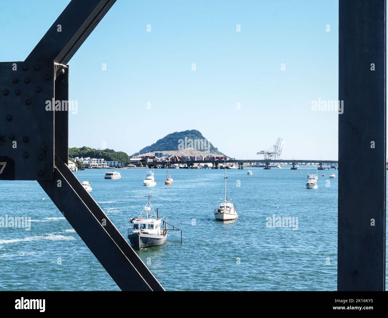 View of Tauranga Harbour through structural pattern of steel bridge ...