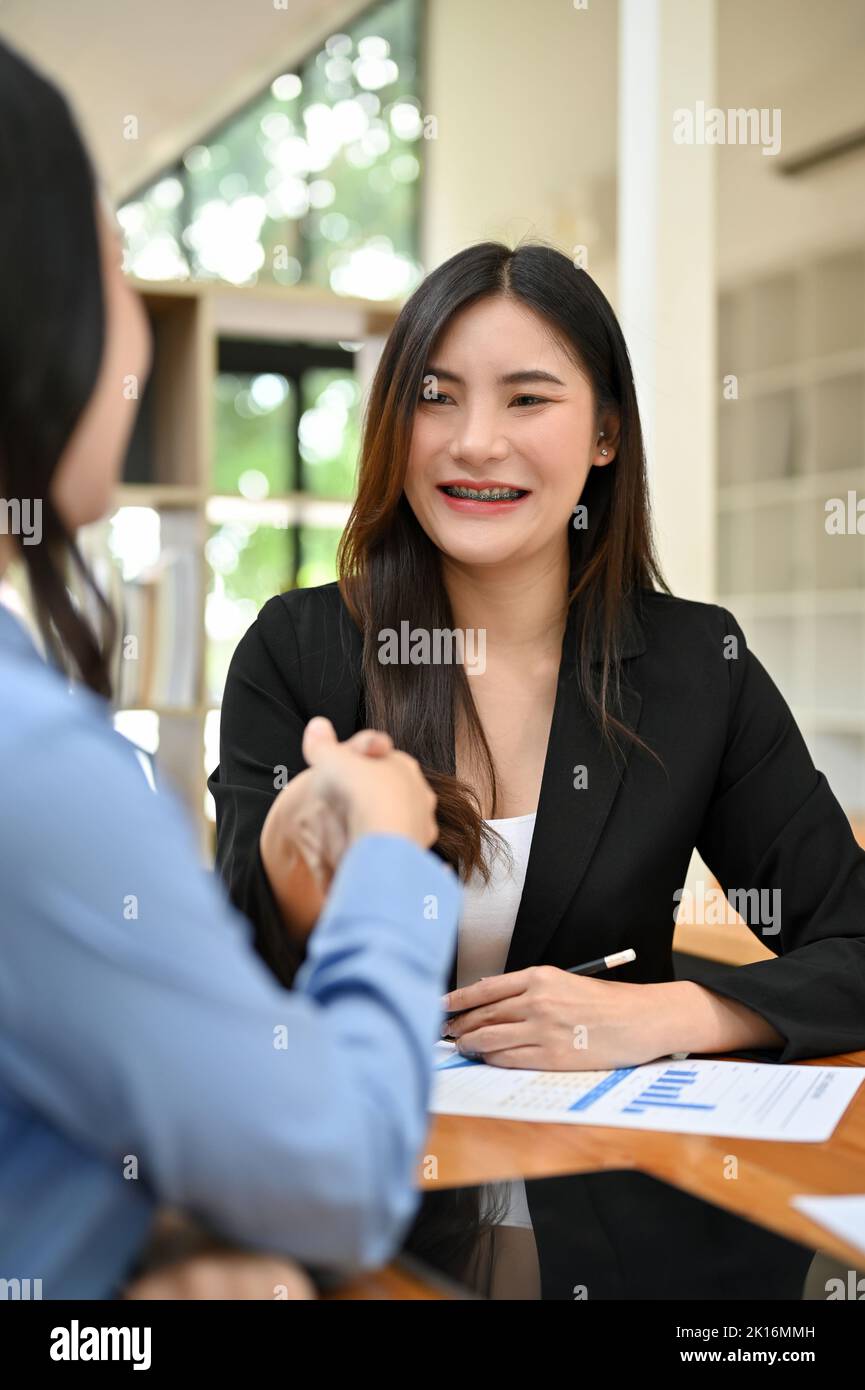 Portrait, Charming and beautiful young Asian businesswoman shaking ...