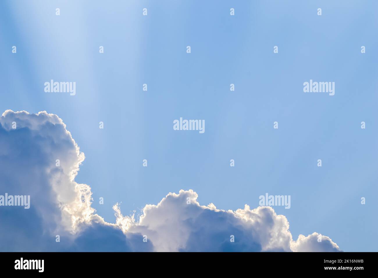 Background from blue sky with sun rays across clouds. High quality ...
