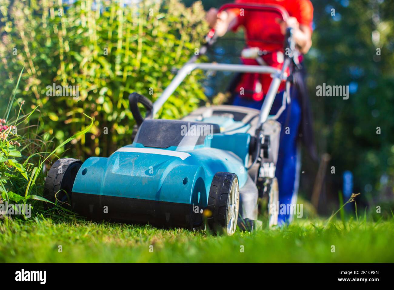 Lawn mover on green grass in modern garden or backyard. Machine for ...