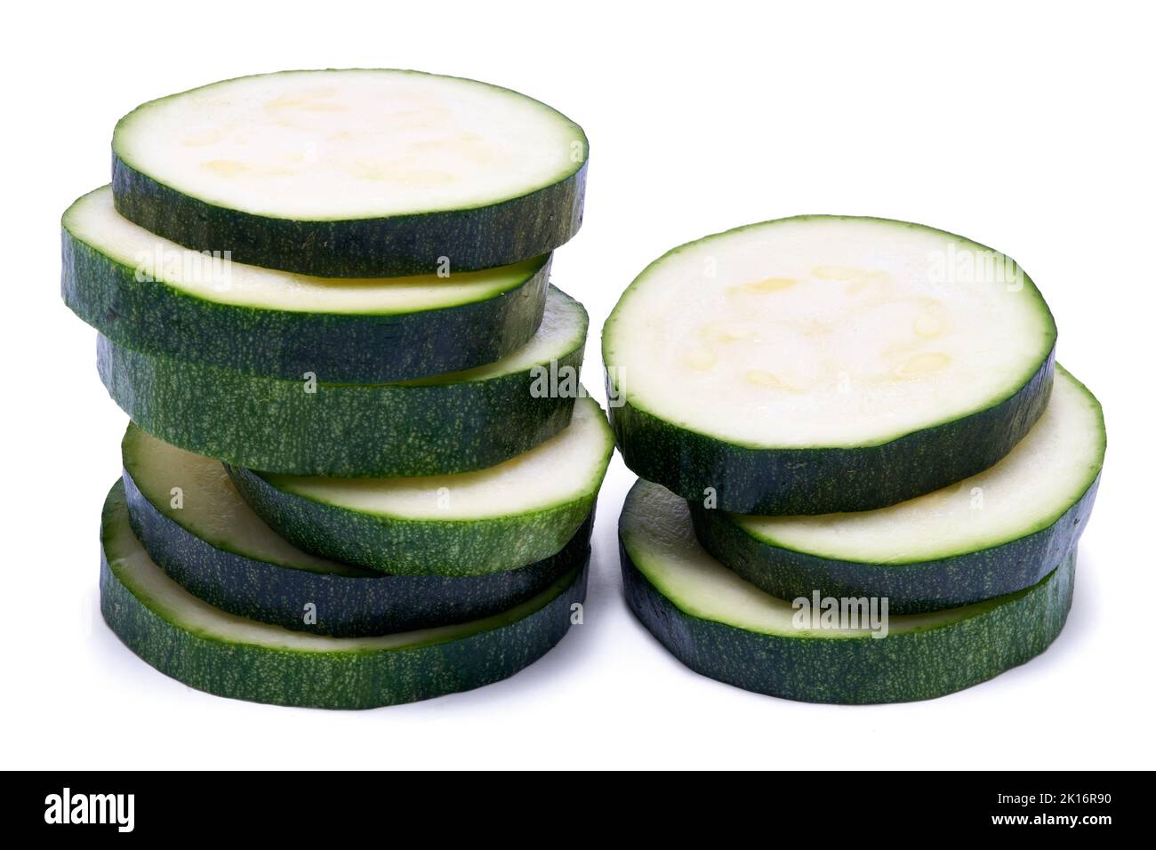 Sliced zucchini circles isolated on white background Stock Photo - Alamy