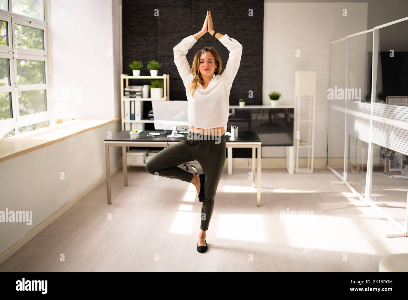 Stretch Exercise Standing Near Desk In Office Stock Photo - Alamy