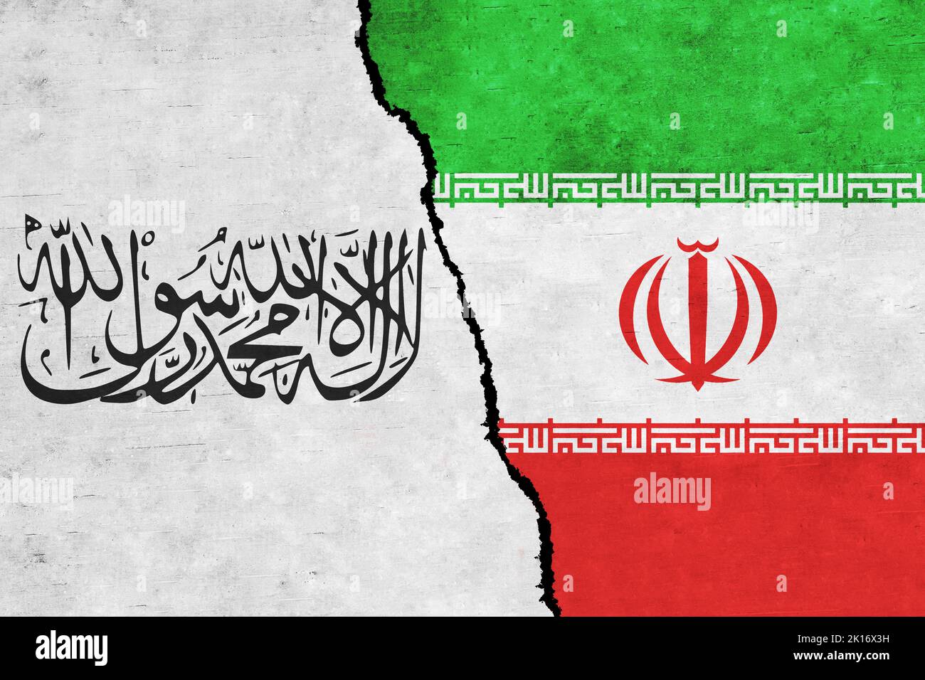 Iran and Taliban painted flags on a wall with a crack. Taliban and Iran ...