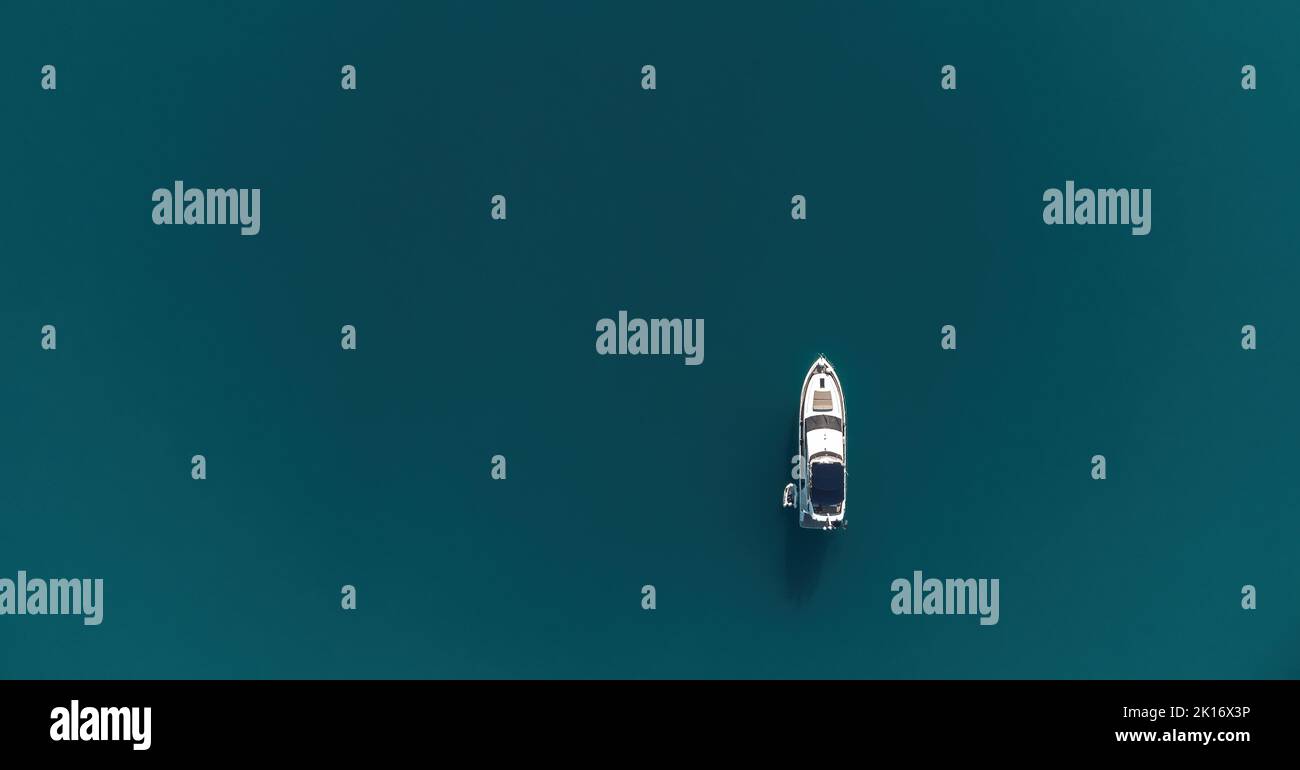 Aerial yacht on calm sea. Luxury cruise trip. View from above of white ...