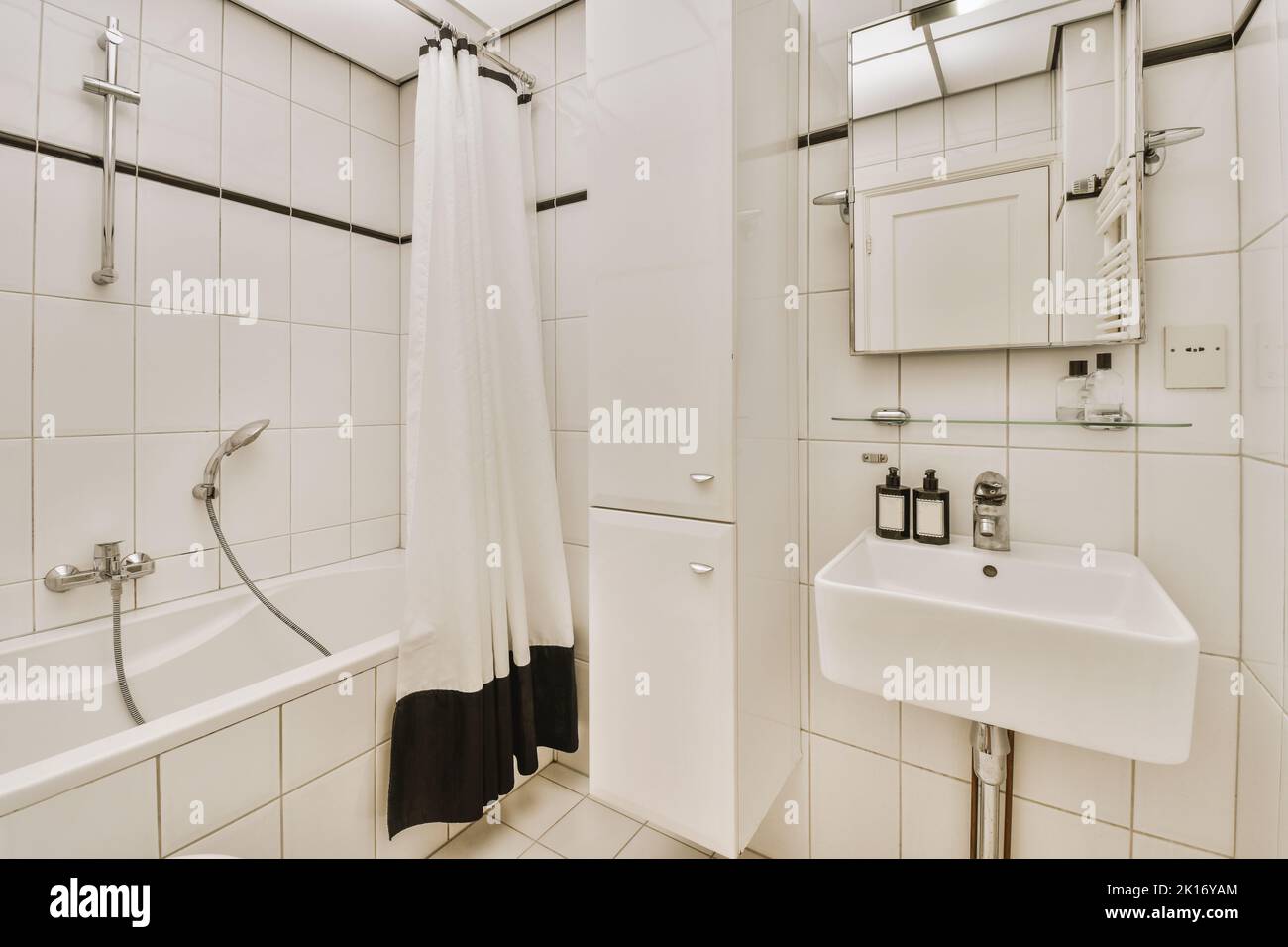 Sinks with mirrors and clean bathtub in modern bathroom with white ... Sinks with mirrors and clean bathtub in modern bathroom with white ...