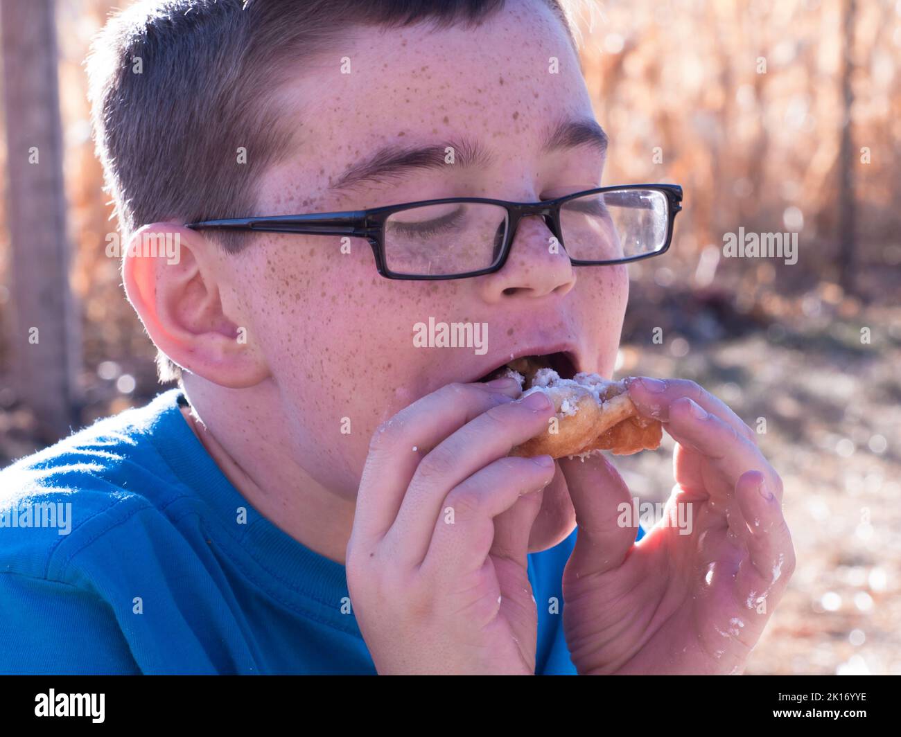 Young Boy Eating Funnel Cake Stock Photo - Alamy