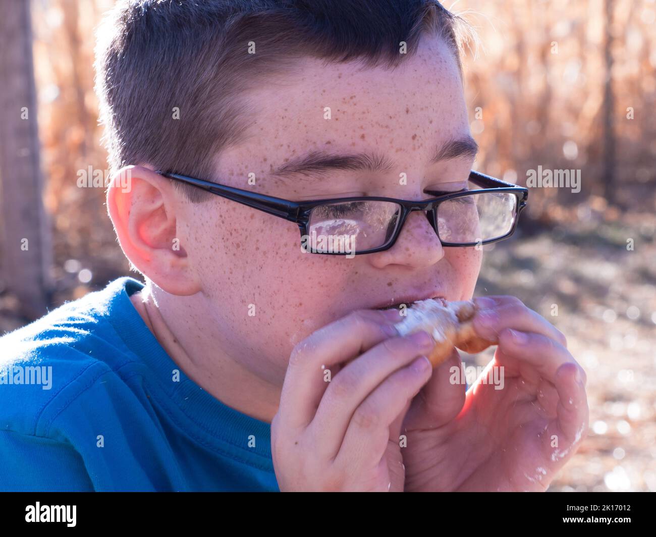Young Boy Eating Funnel Cake Stock Photo - Alamy