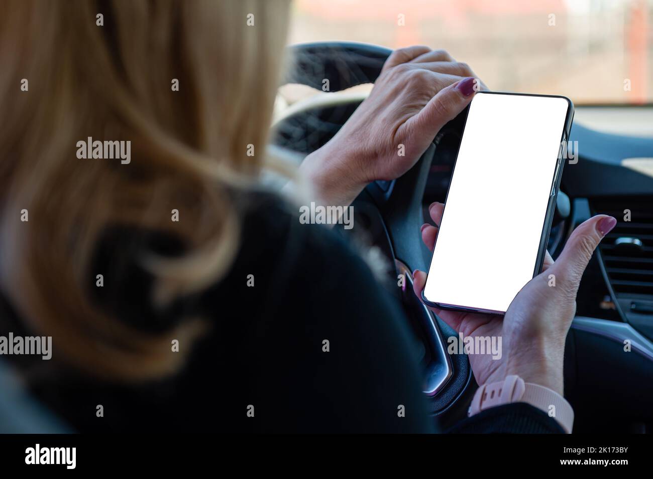 Closeup of Woman holding mobile phone in hands with blank screen while ...