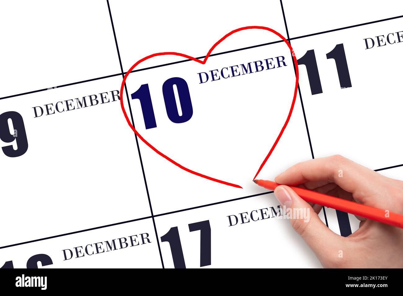10th day of December. A woman's hand drawing a red heart shape on the ...
