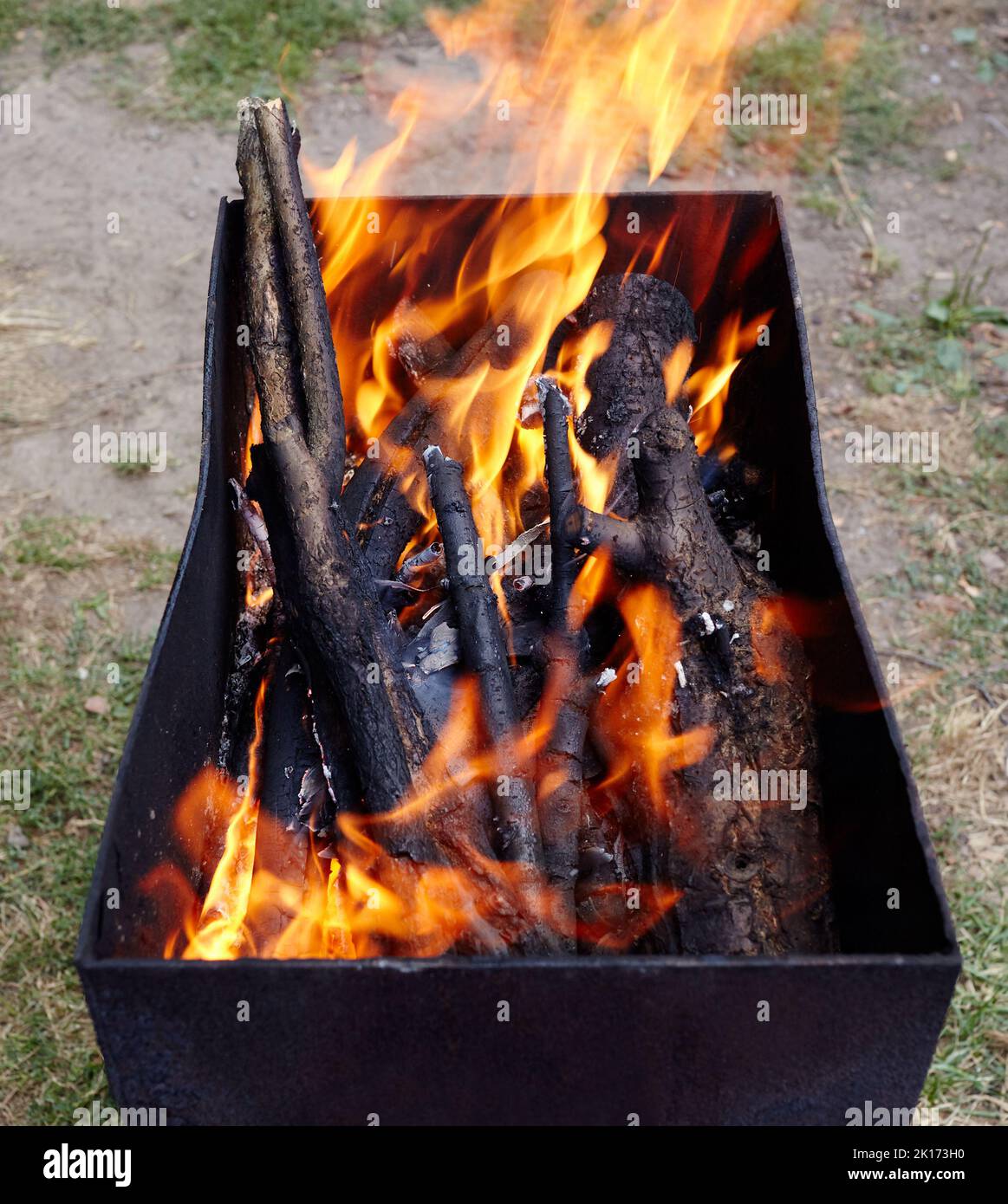 Burning red hot sparks fly from fire. Barbecue gril with glowing and ...