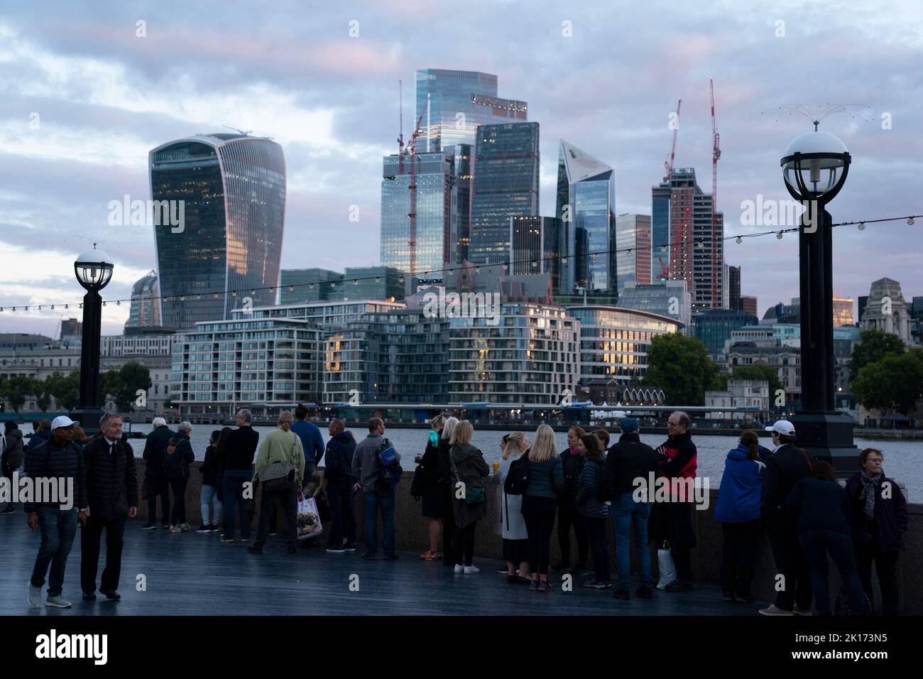 Members of the public in the queue at 06:34 on The Queen's Walk ...