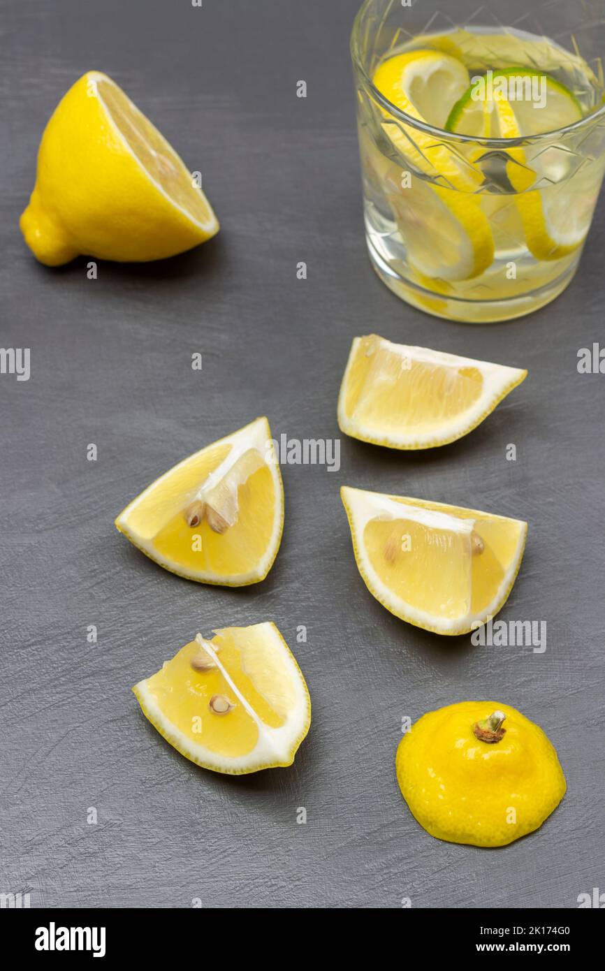 Lemon slices on table. Glass with summer lemon drink. Top view. Grey ...