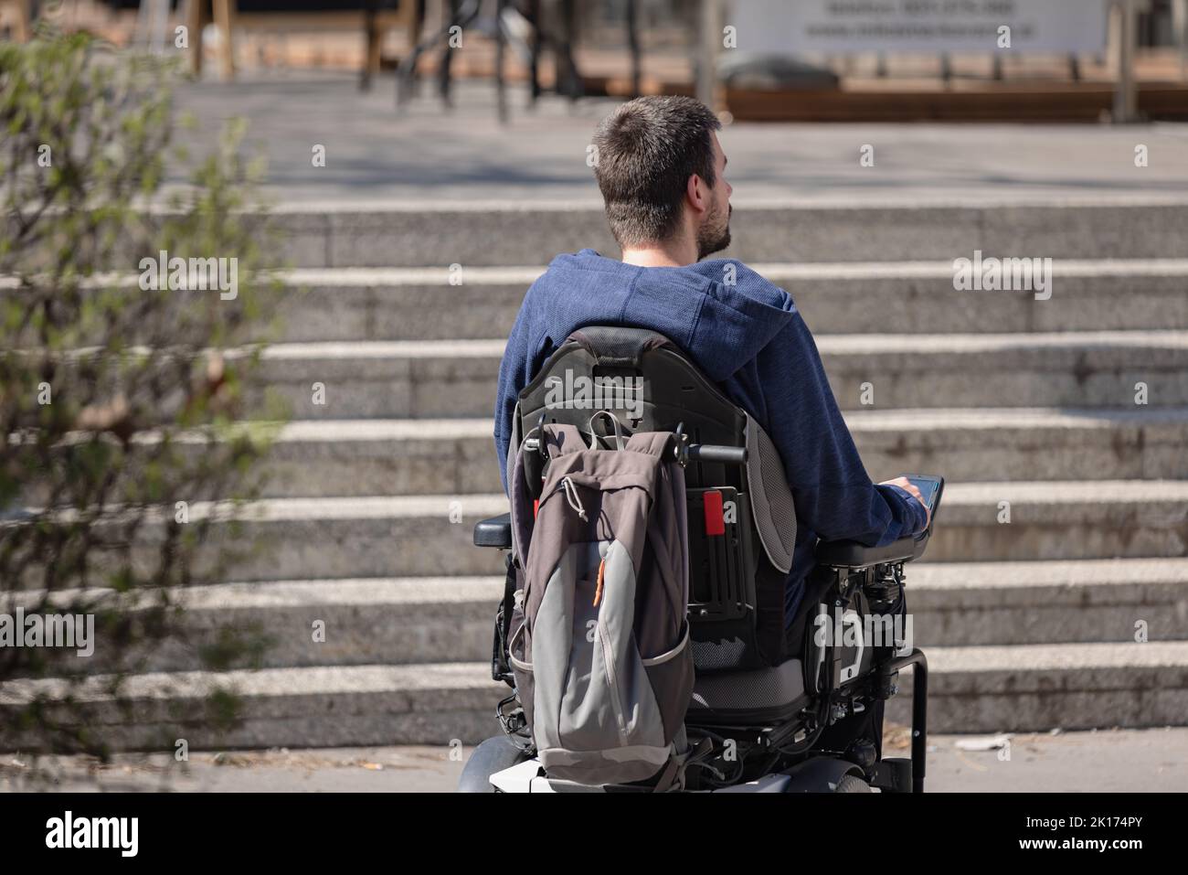 Person with disability on electric wheelchair stopping at the bottom of ...