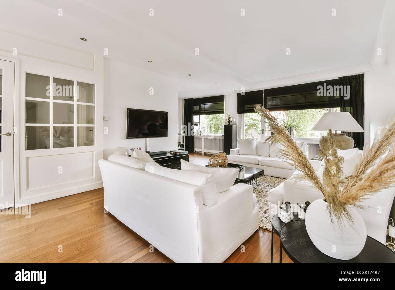 Stylish interior design of living room with light furniture and soft ...