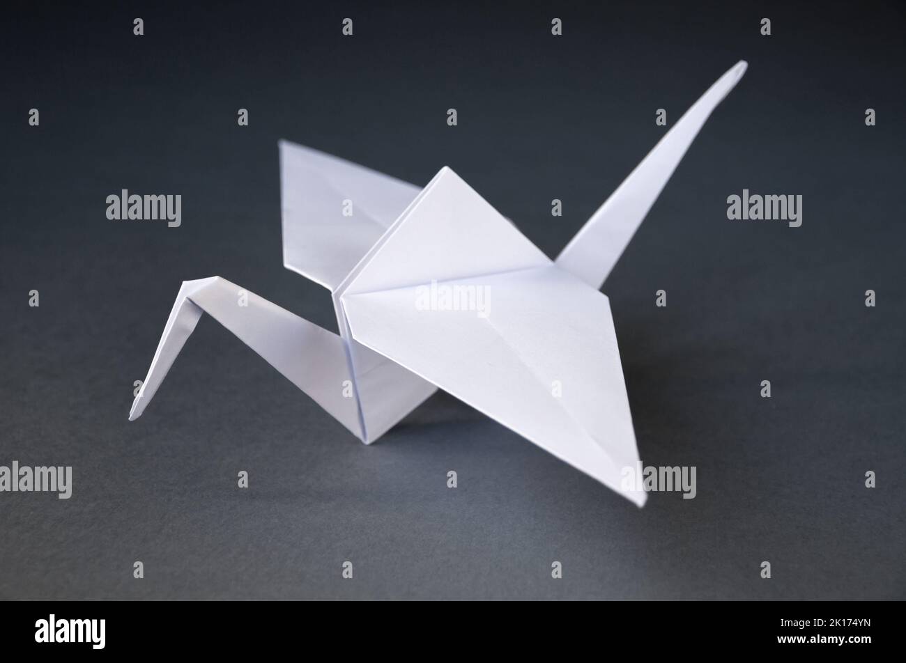 White paper crane origami isolated on a blank grey background Stock ...