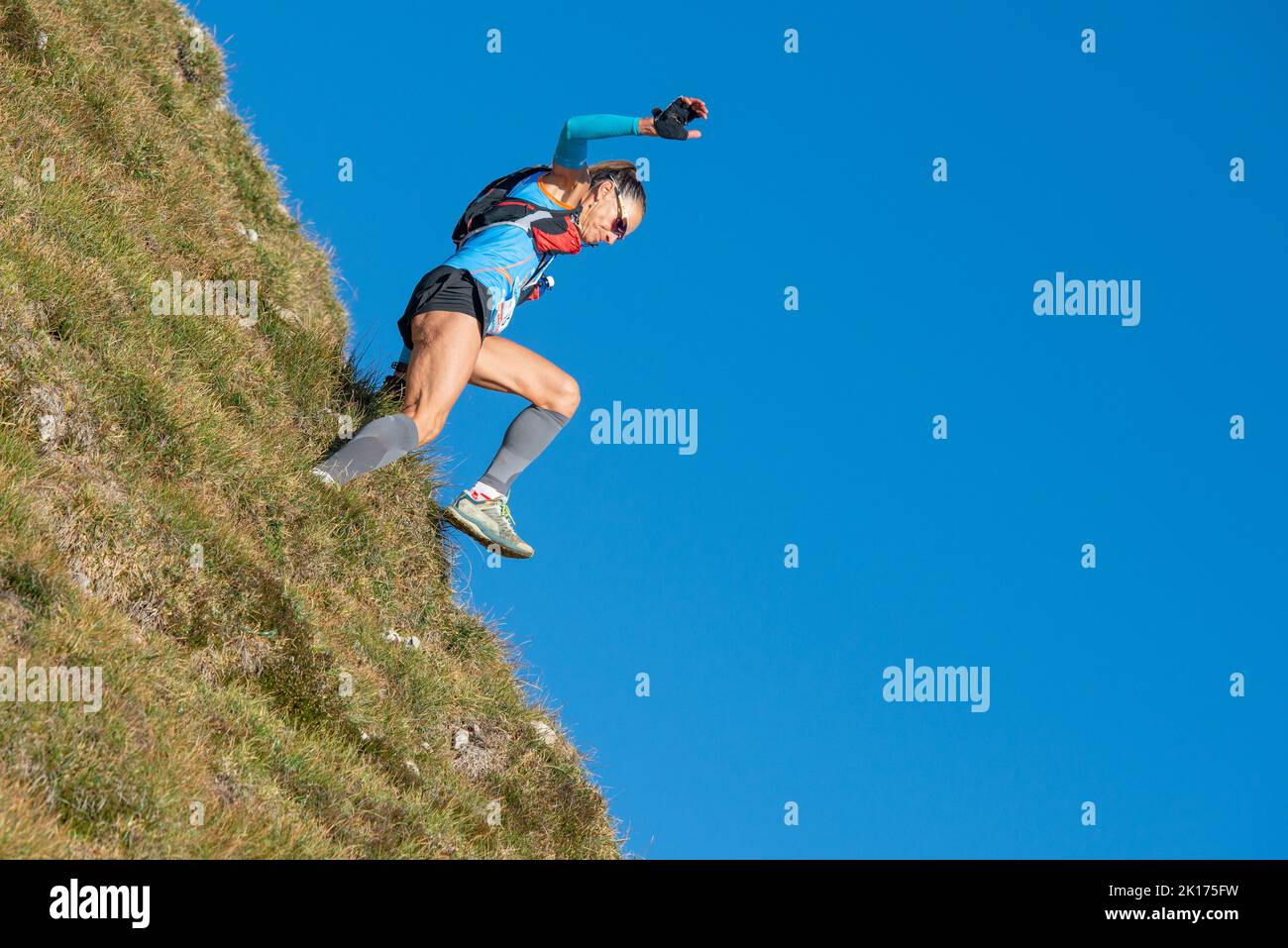 Girl running on the mountain peaks Stock Photo - Alamy