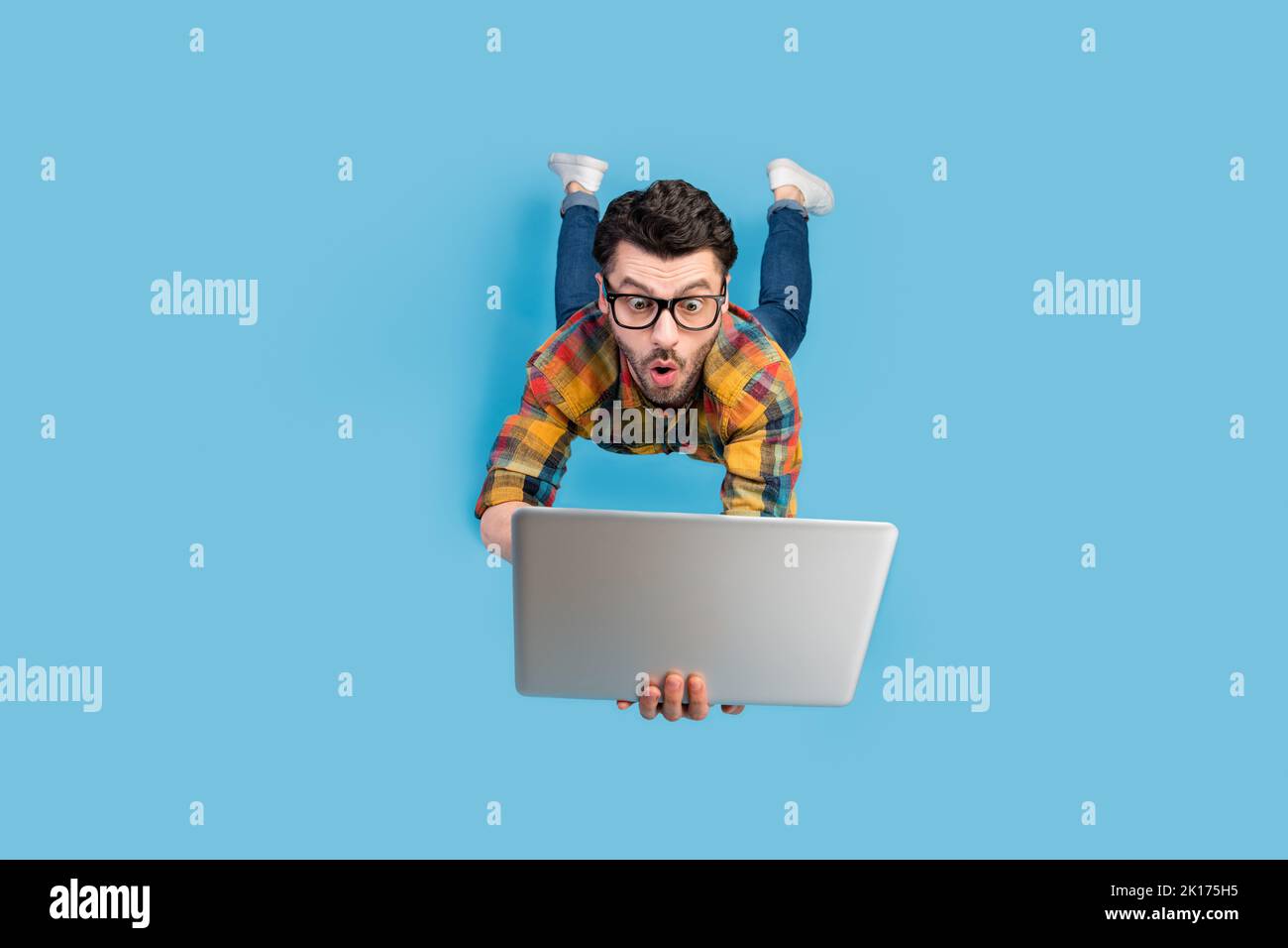 Full size portrait of craze geek man falling hands hold use netbook ...