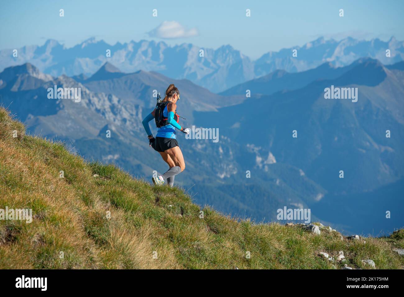 Girl running on the mountain peaks Stock Photo - Alamy
