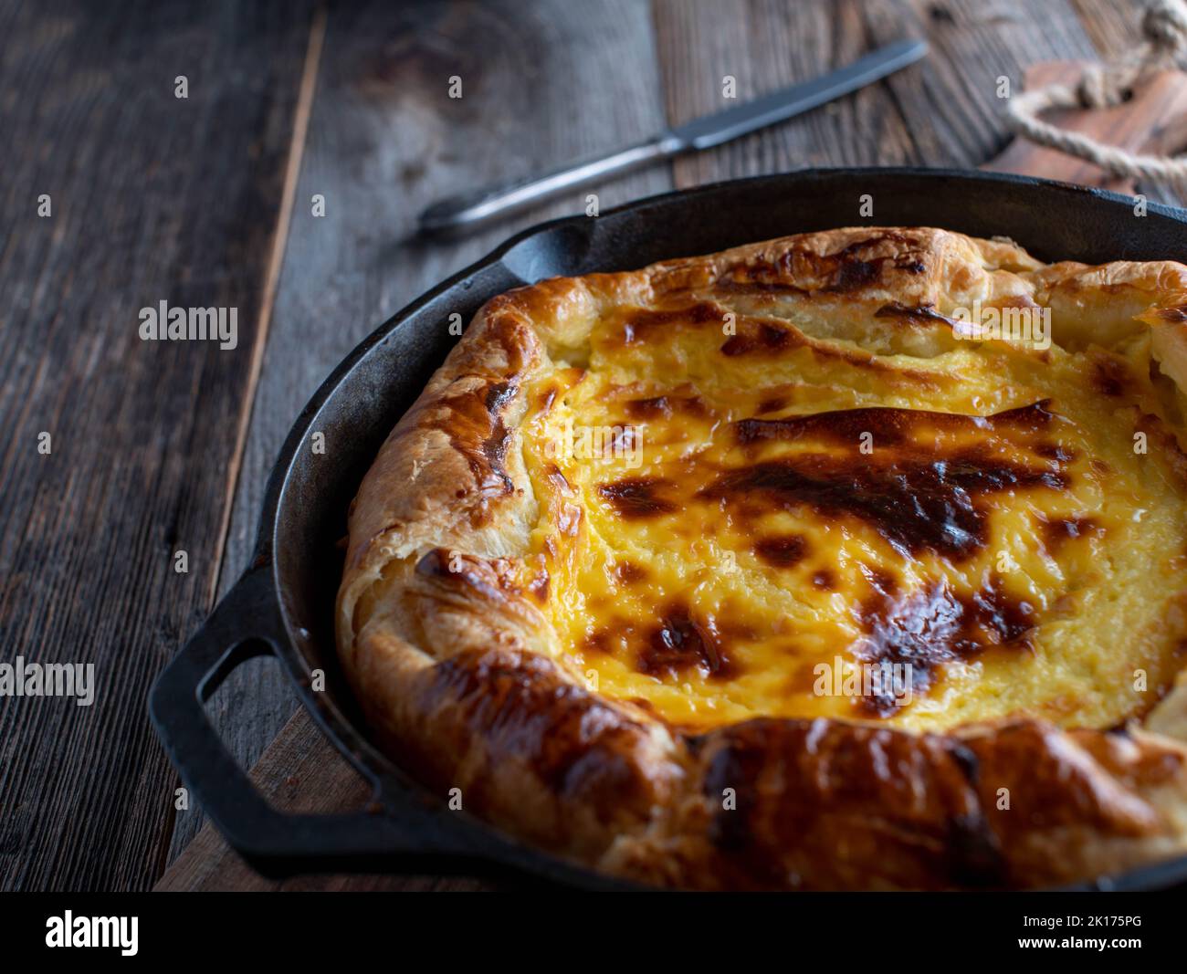 Puff pastry tart with sour cream lemon filling baked in a cast iron pan ...