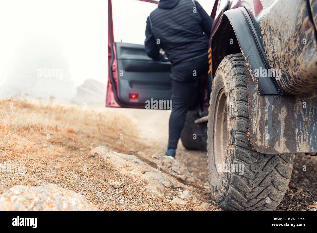 Bottom POV view male person driver open door of 4x4 awd suv vehicle on ...