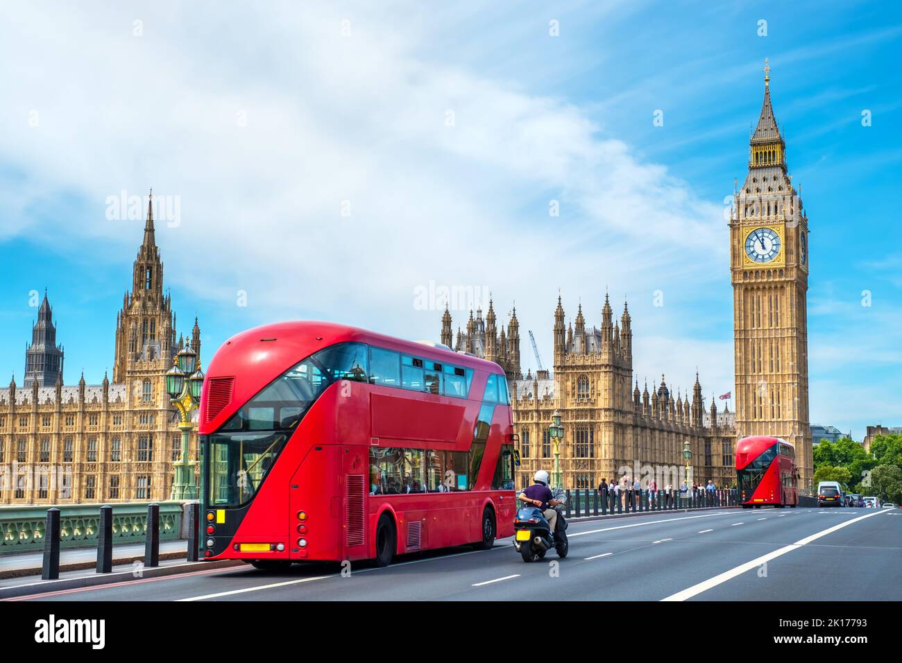 Red double-decker buses pass by Big Ben and the Houses of Parliament on ...
