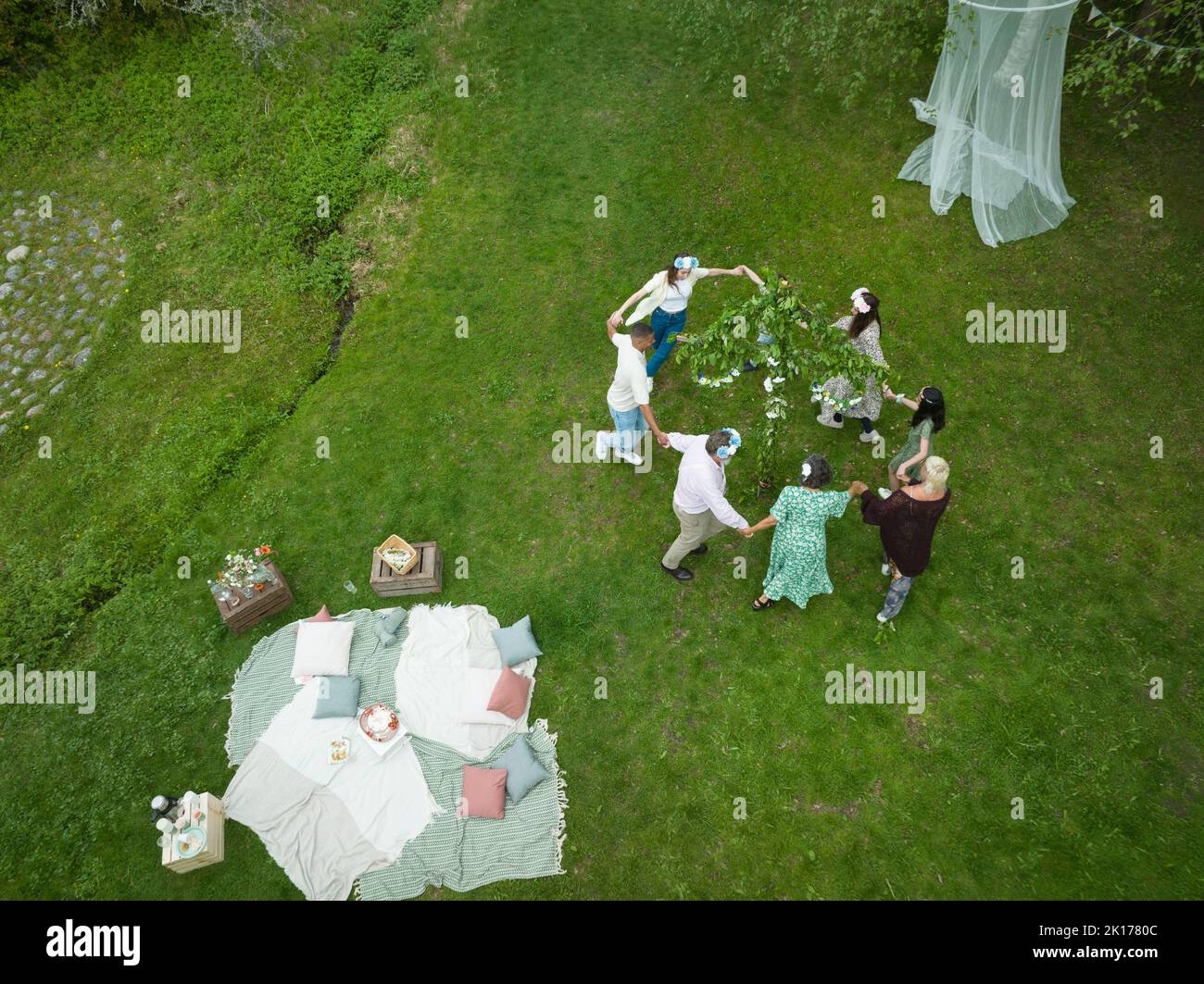 Drone view of people dancing around maypole Stock Photo - Alamy