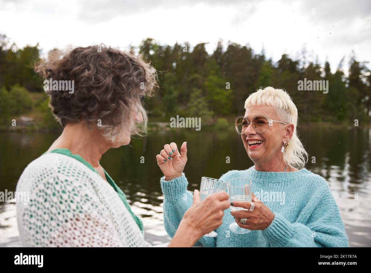 Smiling women talking together Stock Photo - Alamy