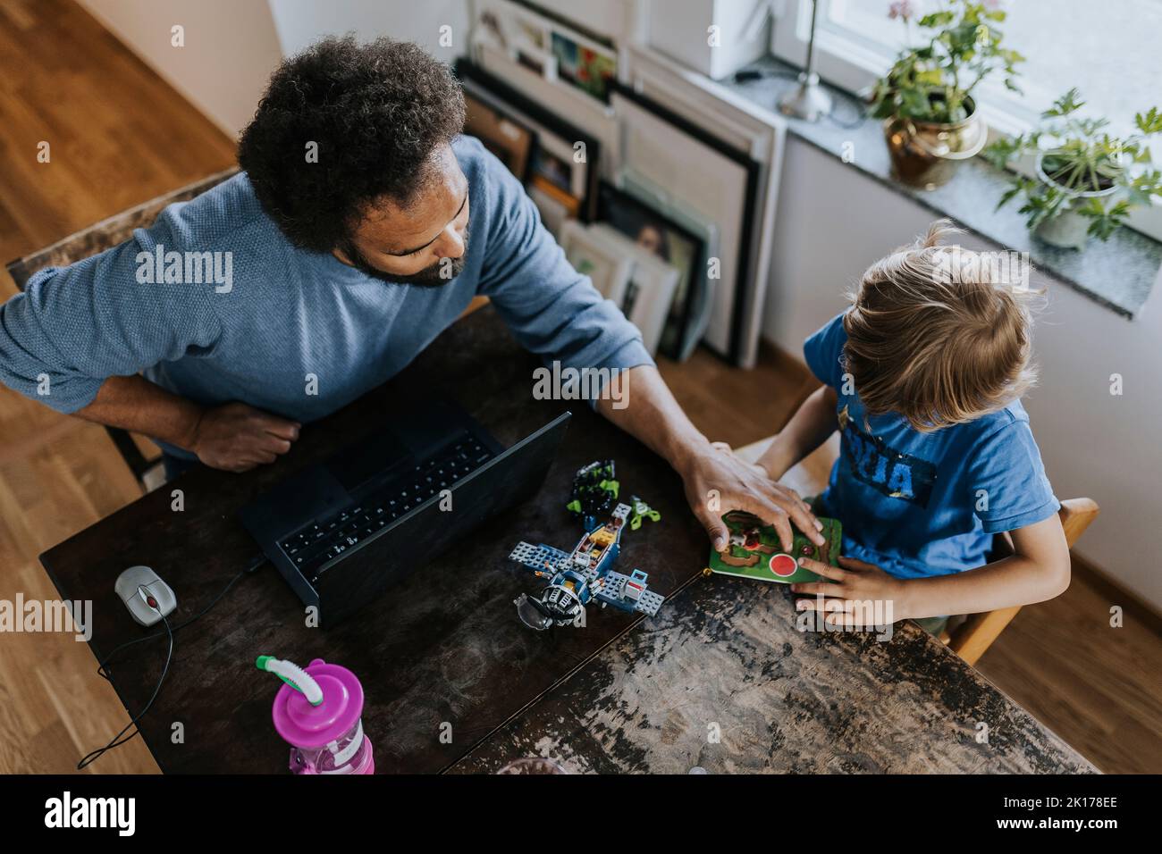 Father working from home and playing with son Stock Photo - Alamy