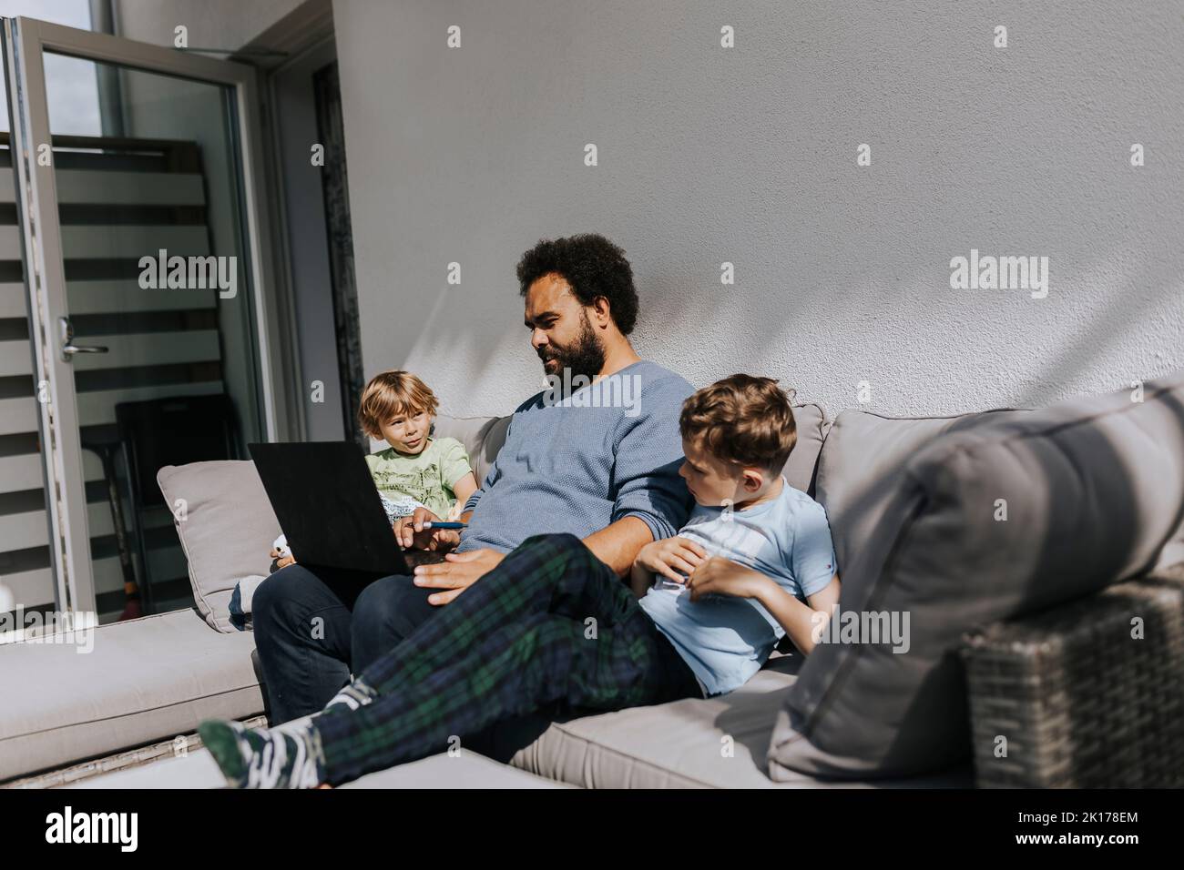 Man working from home and taking care of children Stock Photo - Alamy