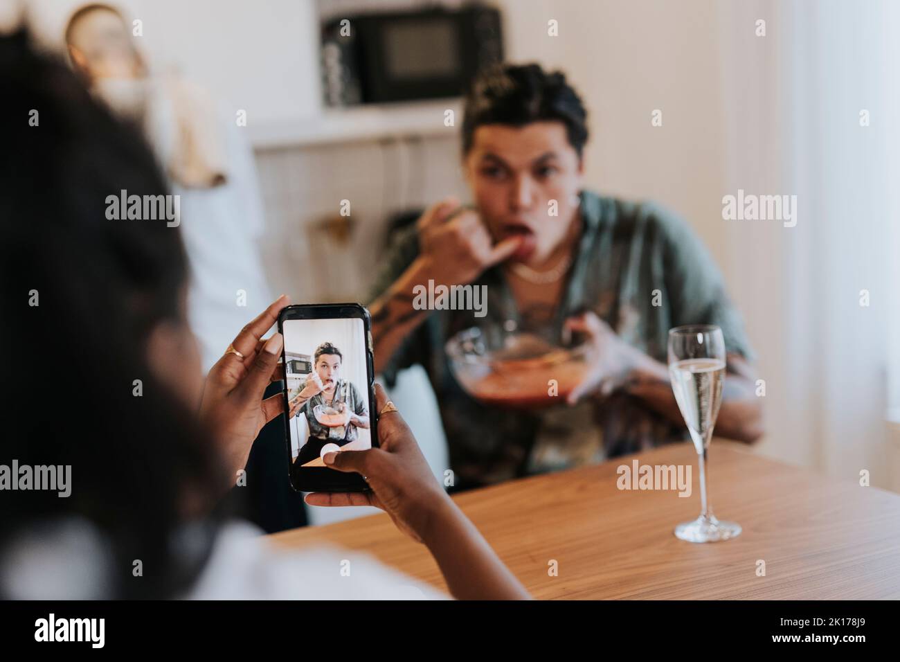 Hand with phone photographing man Stock Photo - Alamy