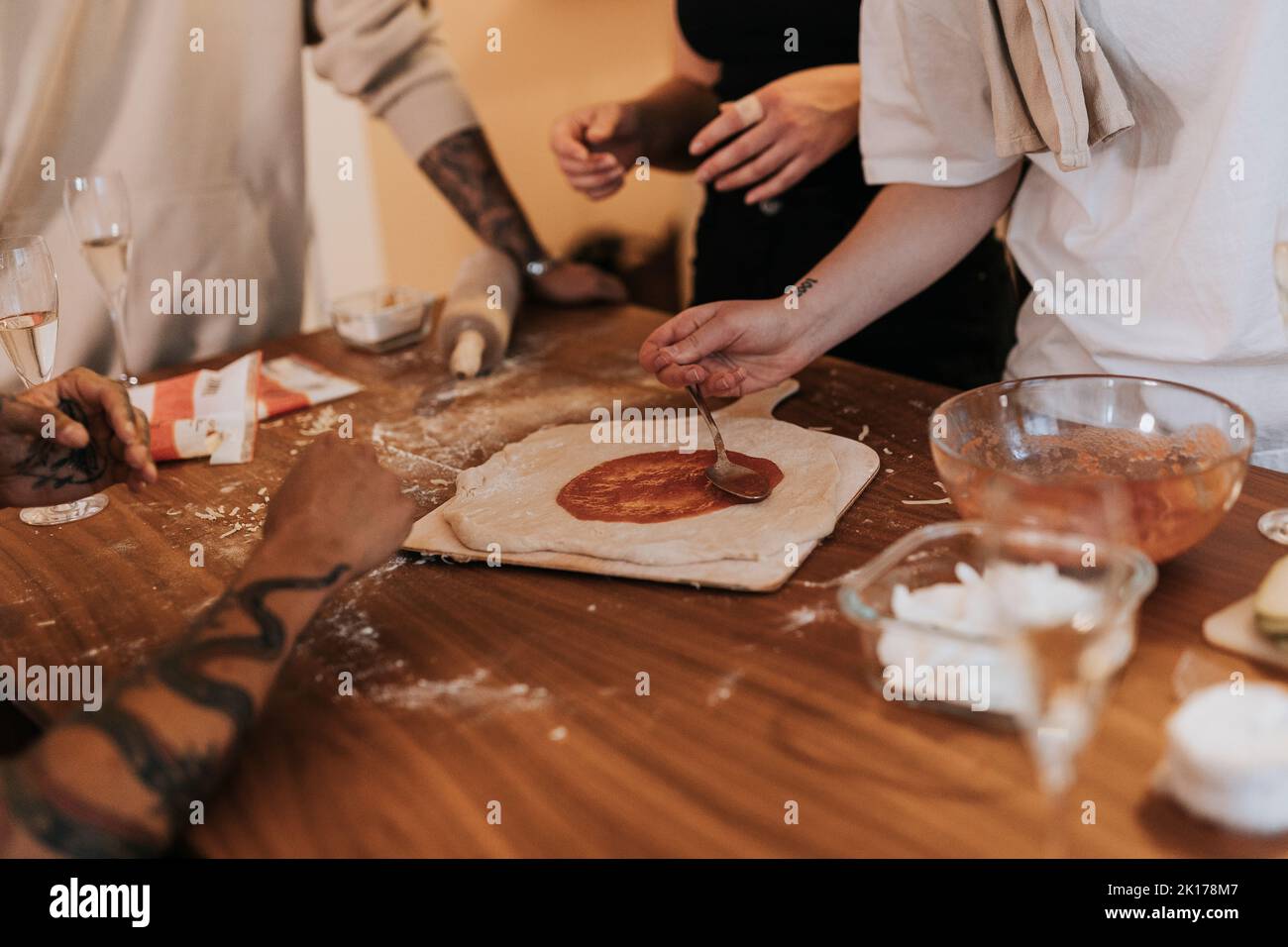 Mid section of people preparing pizza Stock Photo - Alamy