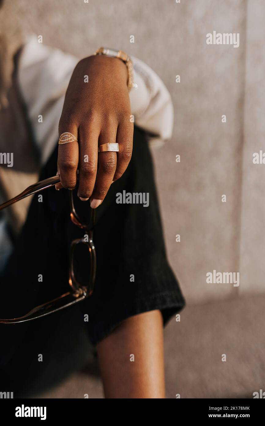 Woman's hand holding sunglasses Stock Photo - Alamy